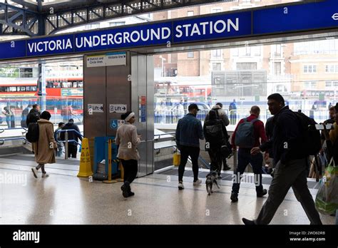 A Busy Entrance And Exit To Victoria Underground Station With The