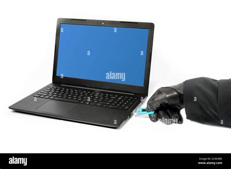 A Cyber Hacker Inserting A USB Thumb Drive Into A Computer To Steal Data Stock Photo Alamy