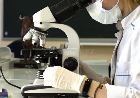 A Female Doctor Conducts Medical Research Using A Microscope Stock Image Image Of Biology