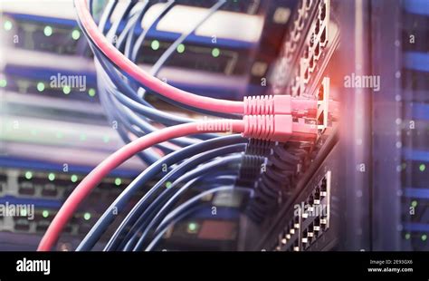 Server Rack With Blue And Red Internet Patch Cord Cables Connected To Black Patch Panel In Data