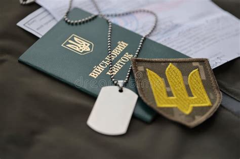 Military Token Or Army Id Ticket With Mobilization Notice Lies On Green Ukrainian Military