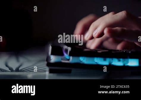 Programmer Typing Code On A Backlit Keyboard In A Dark Room Passionate Work At The Computer