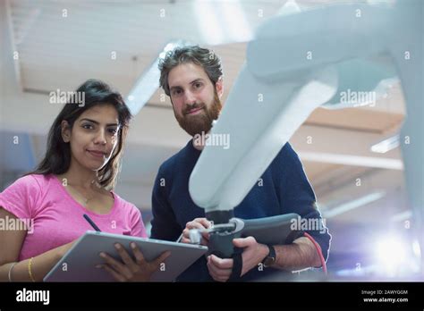 Portrait Confident Engineers With Digital Tablet Programming Robotic