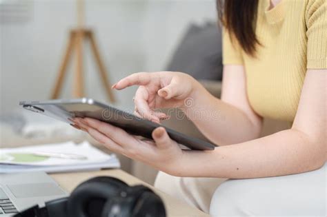 Digital Tools And Efficiency A Woman Interacts With A Tablet To Manage