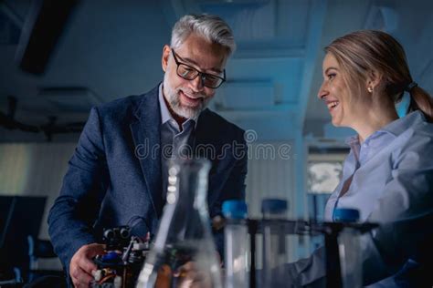 Two Robotics Engineers Working On New Project Standing In Laboratory Concept Of Modern