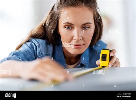 Woman With Ruler Measuring Table For Renovation Stock Photo Alamy