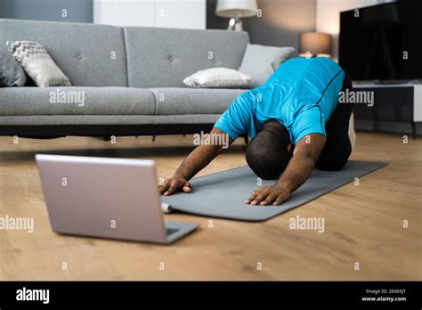 African American Doing Online Stretching Fitness Workout Class At Home
