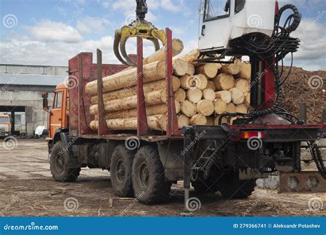 Loading Logs On A Truck Trailer Using A Tractor Loader With A Grab Crane Transportation Of