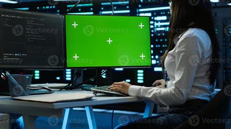 System Administrator Overseeing Data Center Using Green Screen Computer