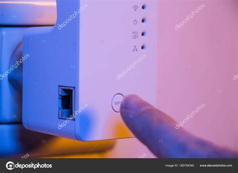 Man Press With His Finger On Wps Button On Wifi Repeater Which I Stock Photo Wavemoviesmw