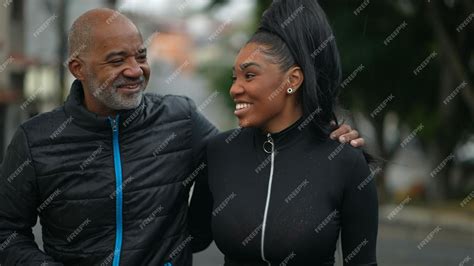 Premium Photo A Black Father And Teen Daughter Walking Together