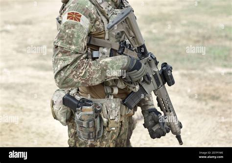 Soldier With Assault Rifle And Flag Of North Macedonia On Military
