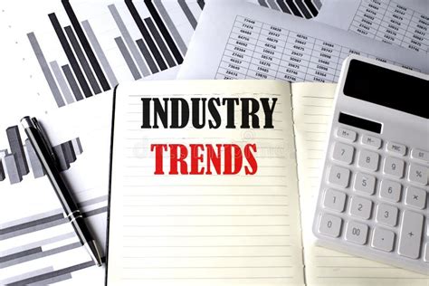 industry trends text written on a notebook on chart and diagram stock
