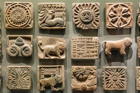 A Close Up Of A Number Of Small Stone Tiles Harappan Seals And Symbols Premium Ai Generated Image