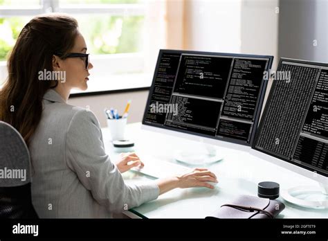 Programmer Woman Coding Software On Computer At Desk Stock Photo Alamy