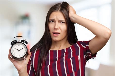 Premium Photo Young Woman Showing Alarm Clock