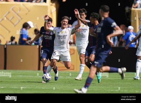 Real Madrids Arda Guler 15 Is Fouled From Behind By Paris Saint