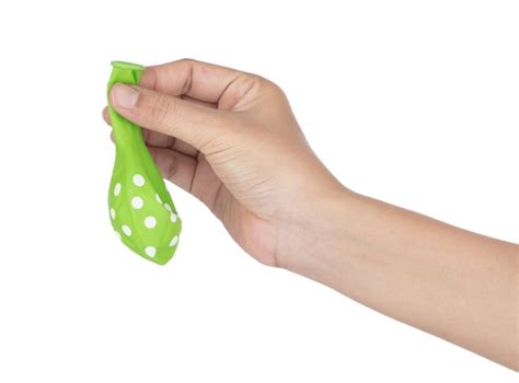 Premium Photo Hand Holding Deflated Balloon Isolated On White Background