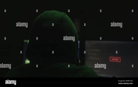Mysterious Hacker Or Programmer With Hoodie Hacking In A Desolate Room