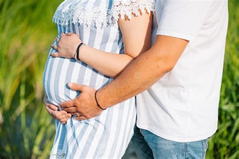 Image of Pregnant Couple. Husband Touching His Wife Belly with Hands ...