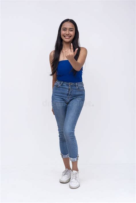 A Friendly Young Filipino Woman Inviting Someone Gesturing With Finger