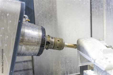 The Five Axis Computer Numerical Control Cnc Machine While Cutting Sample Aerospace Part