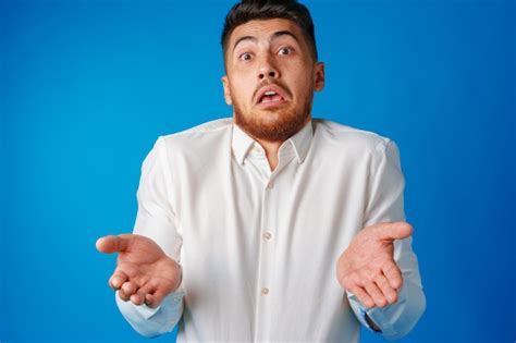 Premium Photo Portrait Of Young Nerd Man Shrugging Shoulders I Dont