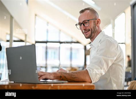 Side View Of A Professional And Smart Caucasian Businessman Or Male Manager Using Laptop
