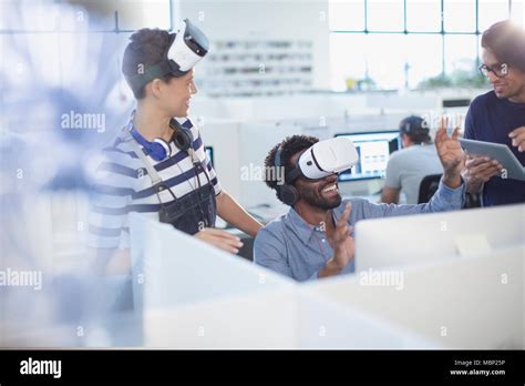 computer programmers testing virtual reality simulators in office stock