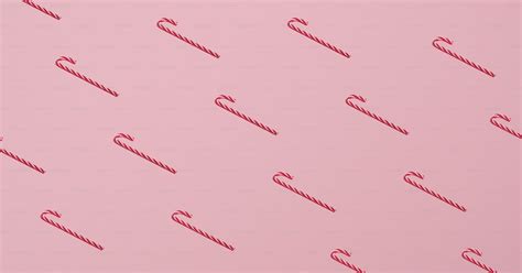 파스텔 핑크 배경에 사탕 지팡이의 패턴입니다 최소한의 스타일 크리스마스 개념입니다 사진 Unsplash의 이음새가 없는 본 이미지