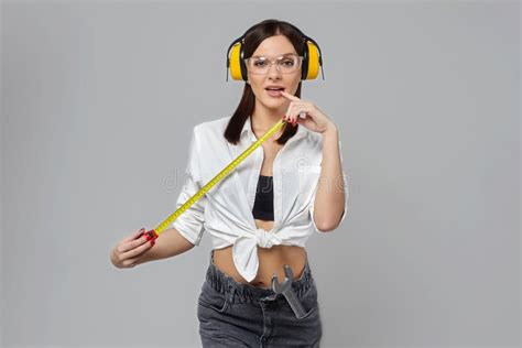 Builder Girl Holding Measuring Tape Concept Of Advertising Construction Services Stock Image