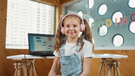 Cute Caucasian Girl Smile At Camera While Laptop Show Coding Screen