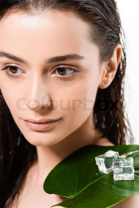 Beautiful Wet Naked Young Woman With Ice Cubes And Green Leaf On