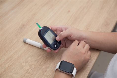 의학 당뇨병 혈당 건강 관리 및 사람들 개념으로 사용하여 포도당 측정기로 혈당 수치를 확인하는 여성의 손을 닫습니다 35 39