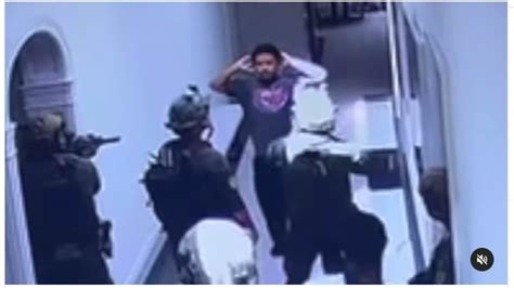 Shocking new footage shows FBI raid on Diddy's LA mansion as heavily-armed agents march his sons ...