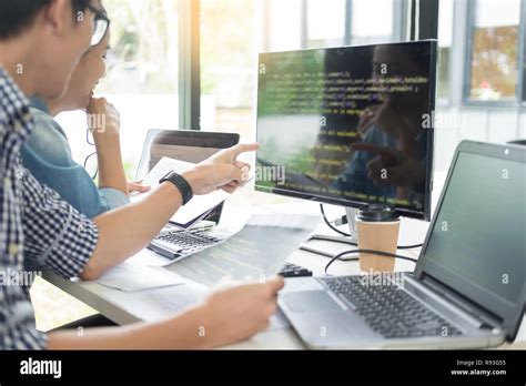 Asian Team Outsource Developer Looking Screen Programming Code Working With Laptop Computer