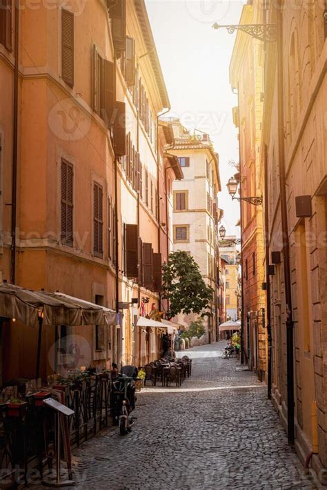 Narrow Cobblestone Street In Trastevere Rome Italy With Cafes