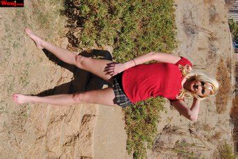 Cute Blonde Girl Lifts Up Her Skirt To Show Her White Panties Photos