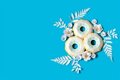 Premium Photo Paper Donuts White Flowers And Leaves
