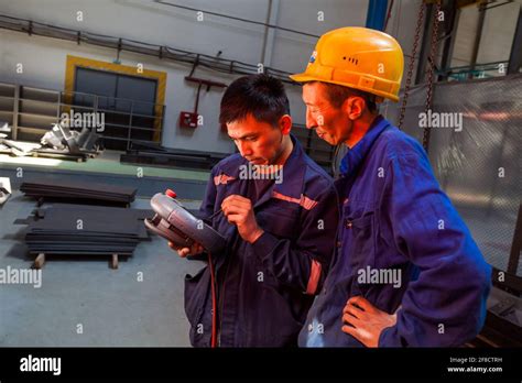 Locomotive Building Plant Two Asian Workers Programming CNC Machine Stock Photo Alamy