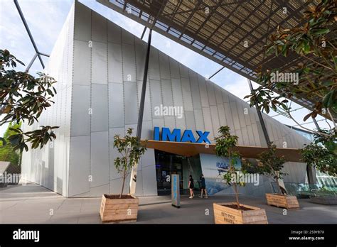 Visitors Walk Under Sloping Roof Striking Architecture And Stark