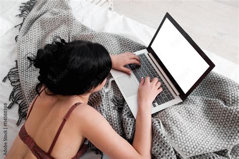 Nude Woman Typing On Laptop With White Screen Laptop With Empty For Advertisement Screen On Bed