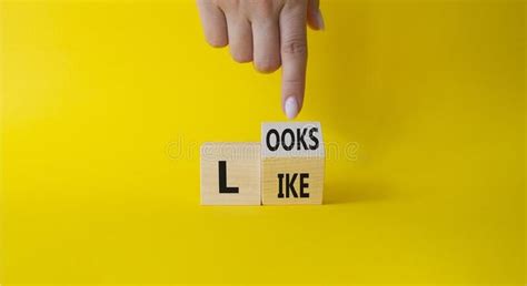 Looks Like Symbol Businessman Hand Points At Turned Wooden Cubes With