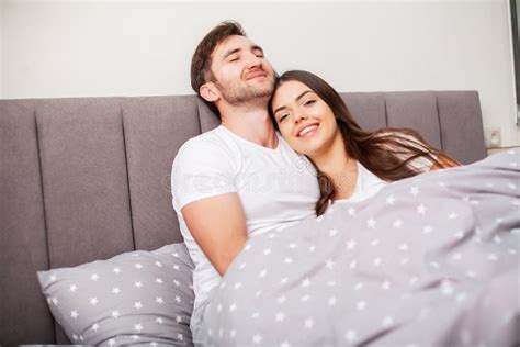 Happy Couple Having Fun In Bedyoung Couple In Bedroom Enjoying Each