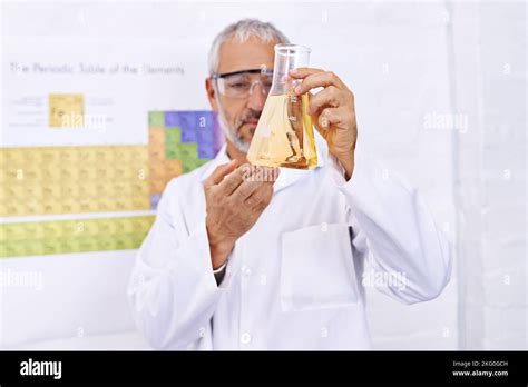 this looks interesting a mature male scientist examining the results