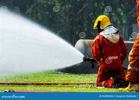 Fire Man Spray Water From Hose For Fire Fighting Firefighter Spraying