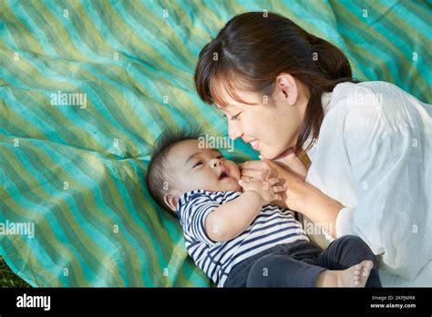 Japanese Mother Cuddling With Her Baby Stock Photo Alamy