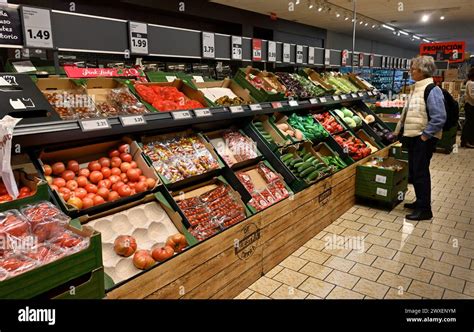 Fruit And Vegetables On Shelves In Lidl Supermarket With Customer Stock Photo Alamy