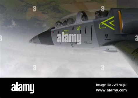 Gray Combat Fighter Plane Make Split S Maneuver Against A Cloudy Sky