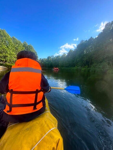 Premium Photo Guys Young Women And Men Raft Down The River In Summer